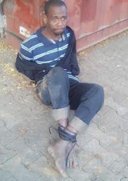 Photos of the Alleged Thief Caught and Tied-up this Morning in Abuja