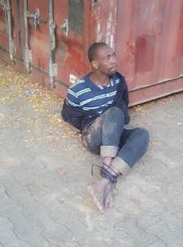 Photos of the Alleged Thief Caught and Tied-up this Morning in Abuja