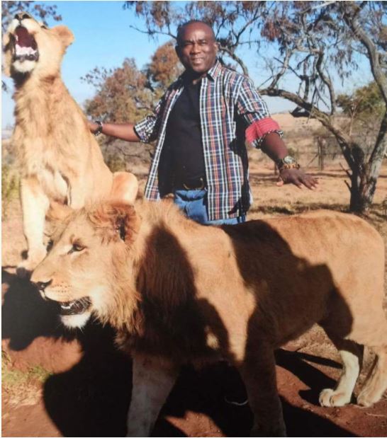 Nigerian Man Poses With Lion in South Africa (Photos)