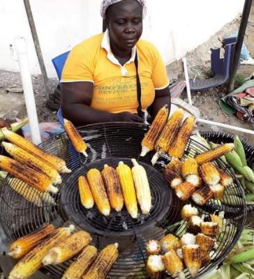 Trending Photo Of Corn Seller Selling Roasted Corn In Bits